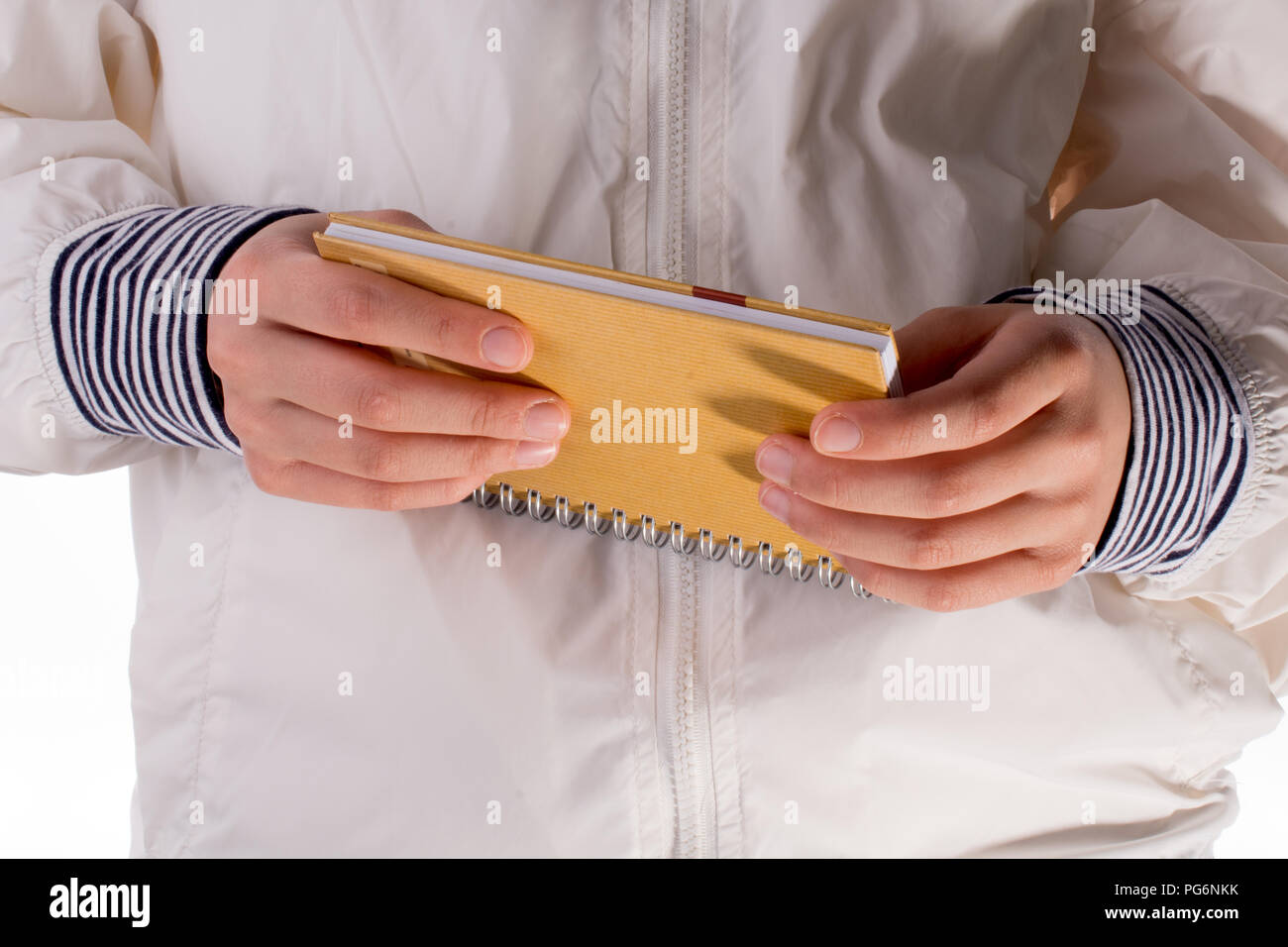 Hand holding a notebook on a white background Stock Photo - Alamy
