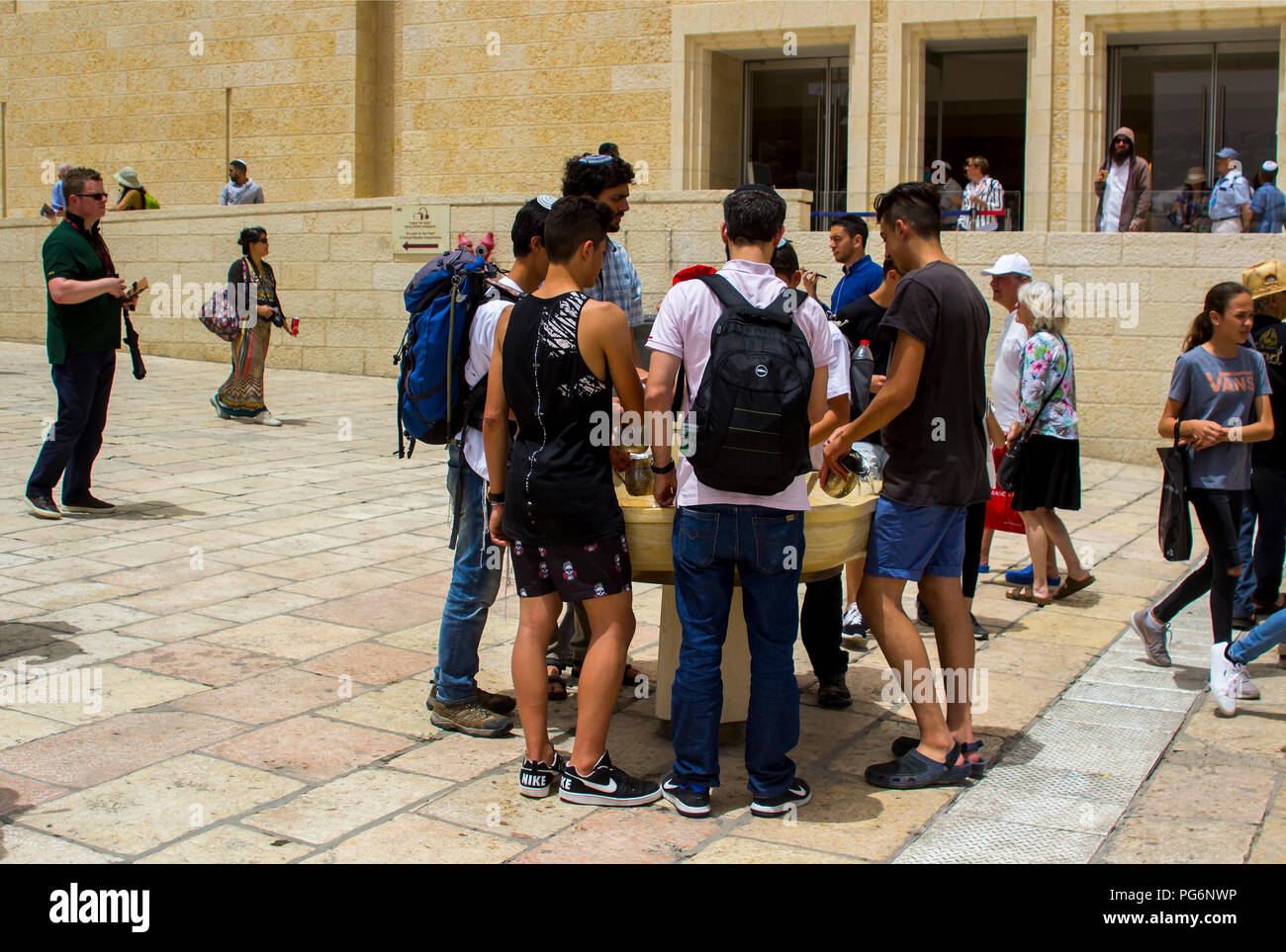 10 May 2018 Jewish males washing and drinking at a water faucet among ...