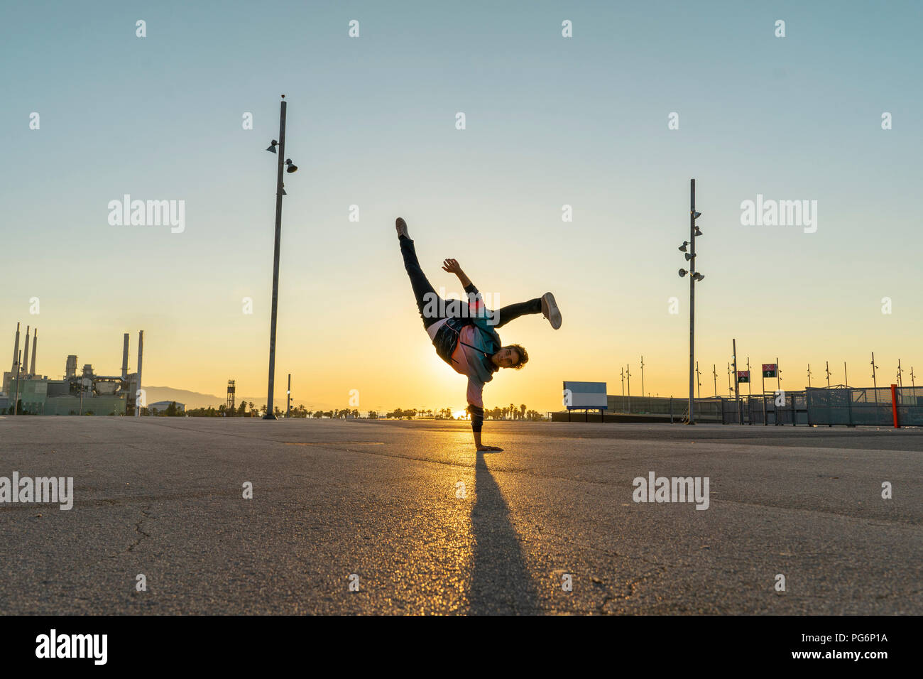 Acrobat doing handstand in the city at sunrise Stock Photo - Alamy