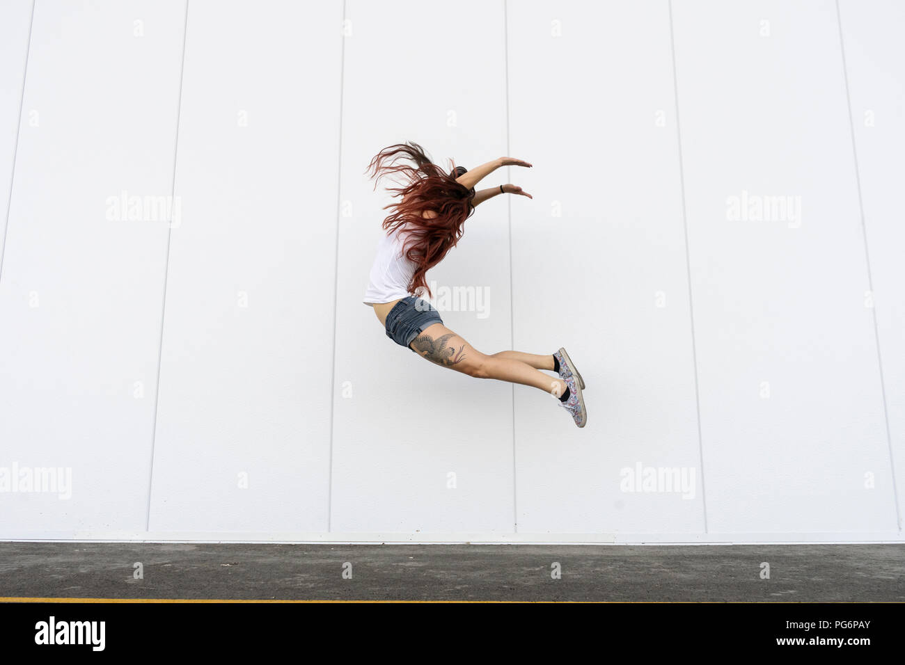 Young acrobat jumping in air Stock Photo - Alamy