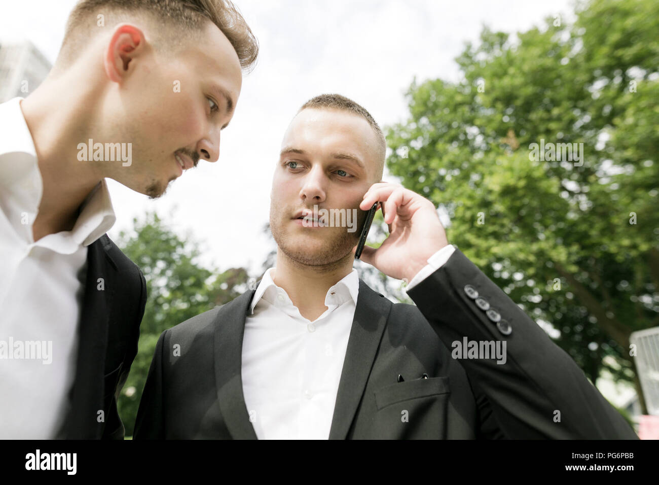 Two person speaking smart phone hi-res stock photography and images - Alamy