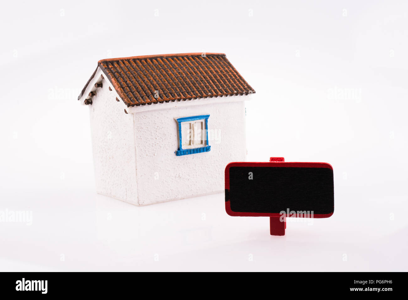 House and sign board on a white background Stock Photo - Alamy