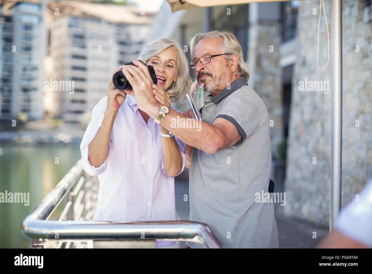 Senior couple taking a city break, taking photos Stock Photo - Alamy