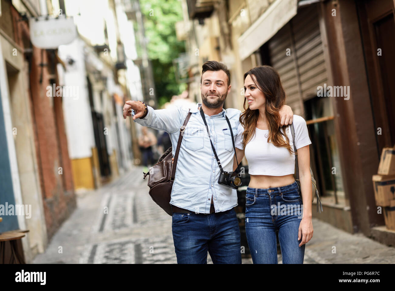 Tourist couple walking and exploring the city Stock Photo - Alamy
