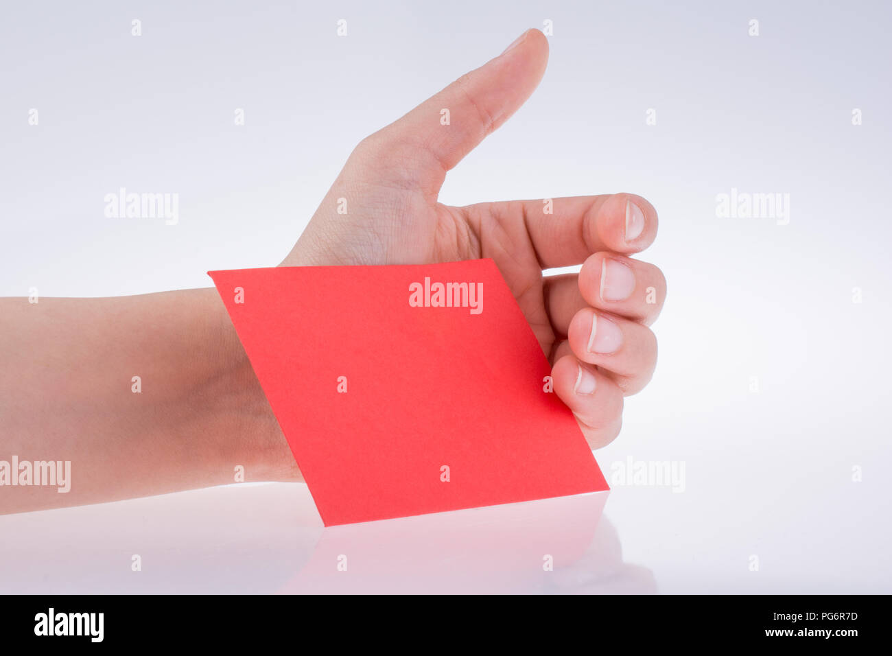 hand holding a red note paper on white background Stock Photo - Alamy
