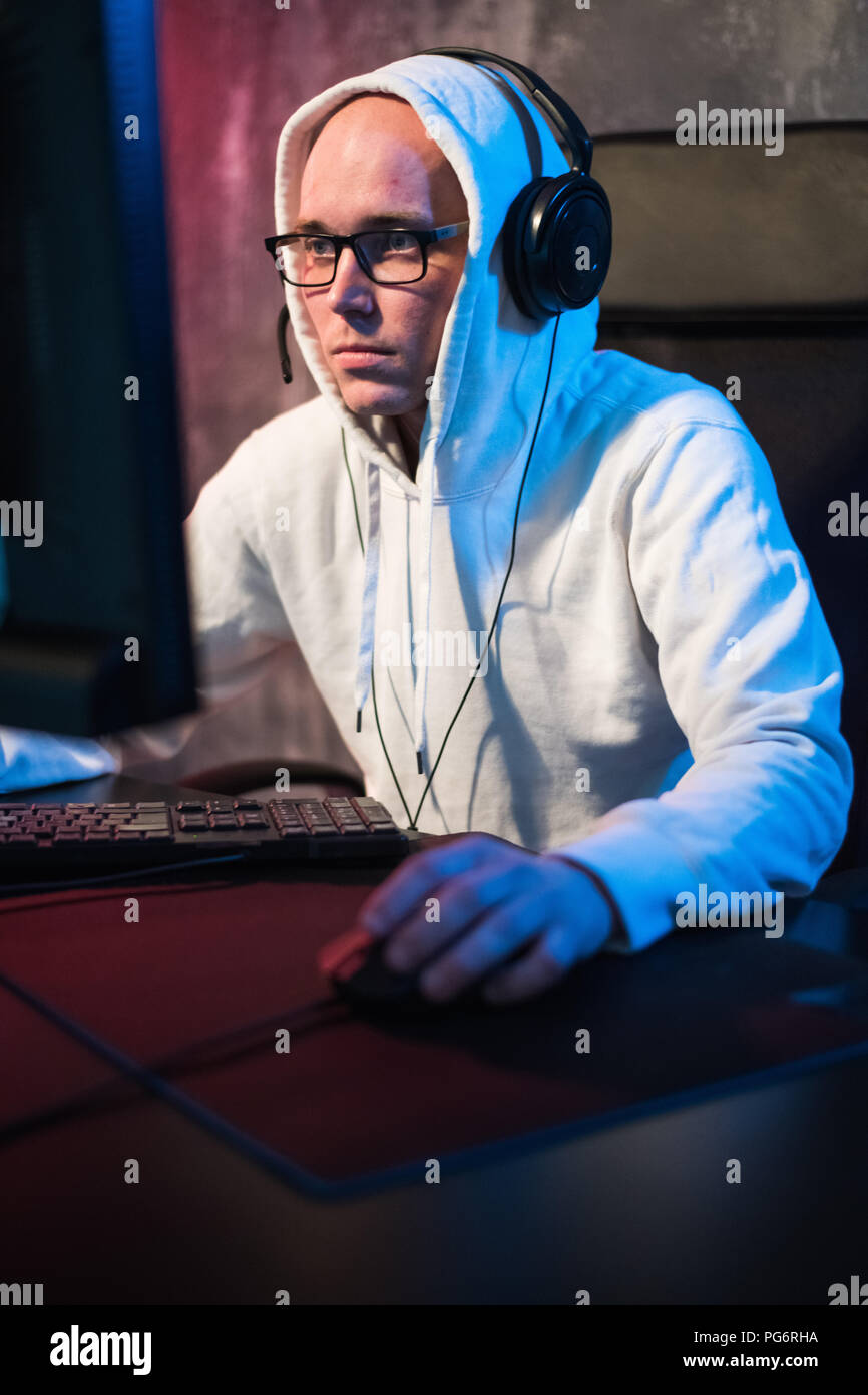 male hooded gamer playing online game on pc computer Stock Photo - Alamy