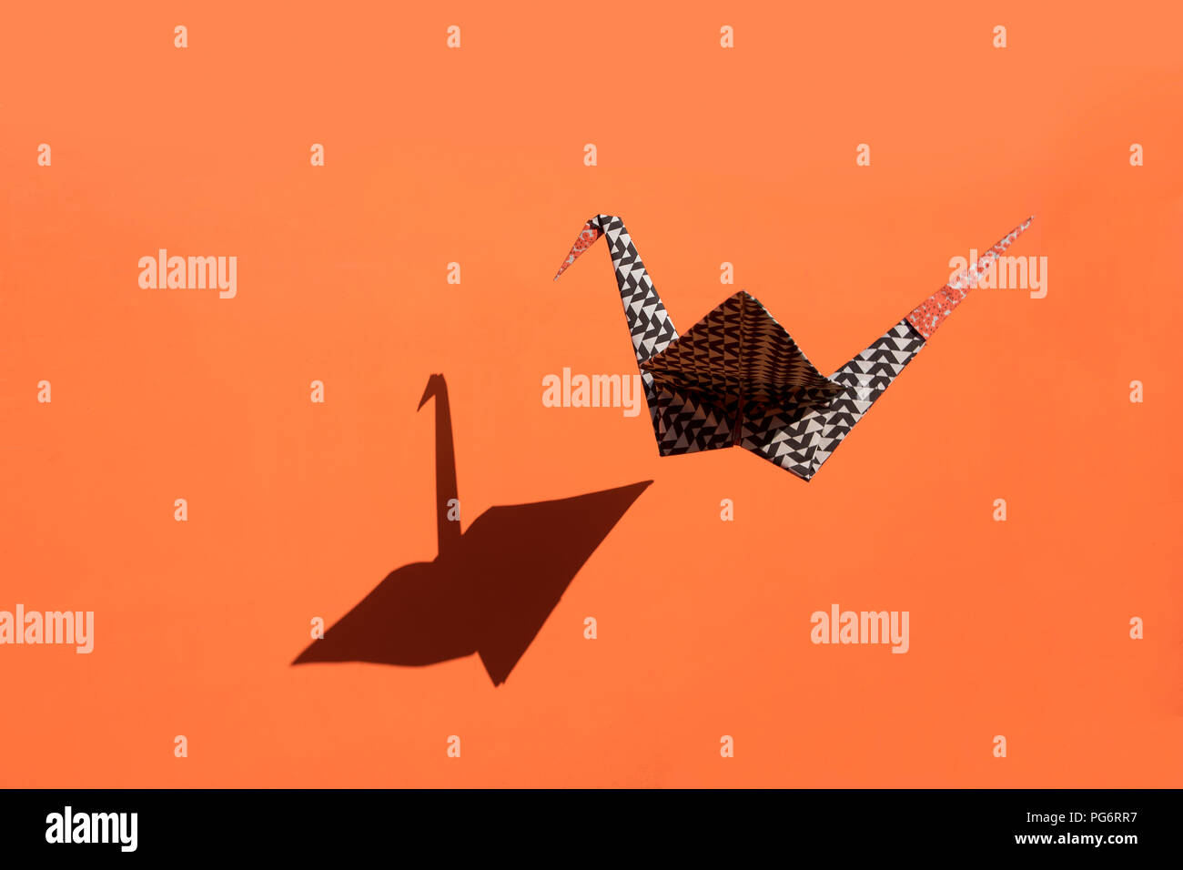 Origami crane, orange background, shadow, copy space Stock Photo - Alamy