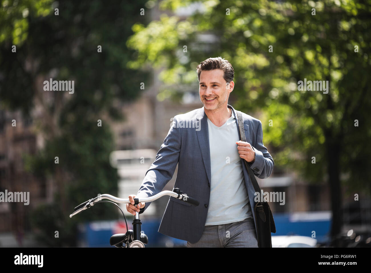 Man pushing his bike hi-res stock photography and images - Alamy