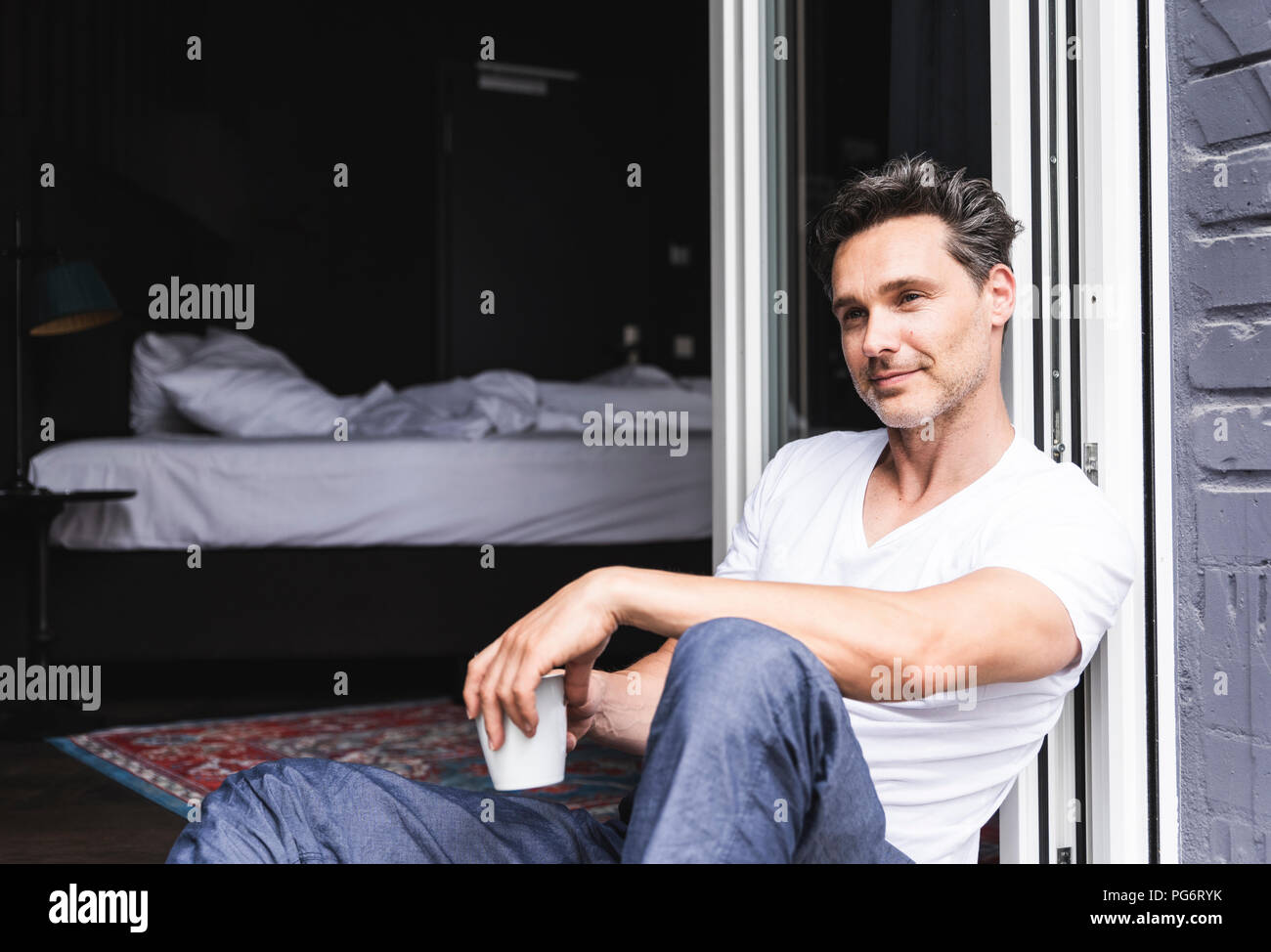 Man sitting window in pajamas hi-res stock photography and images - Alamy