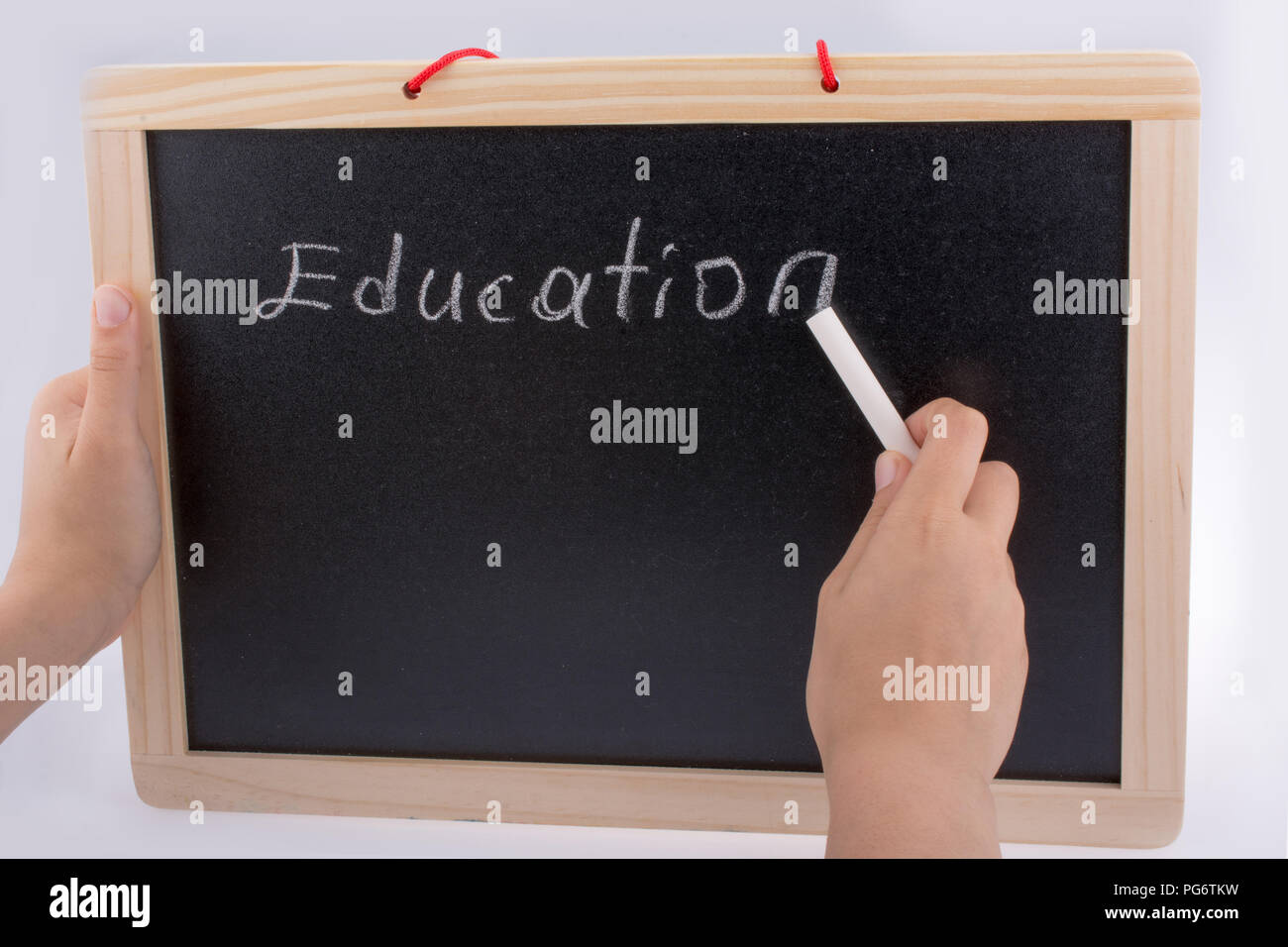 Hand holding a blackboard with 'education' written on it on a white ...