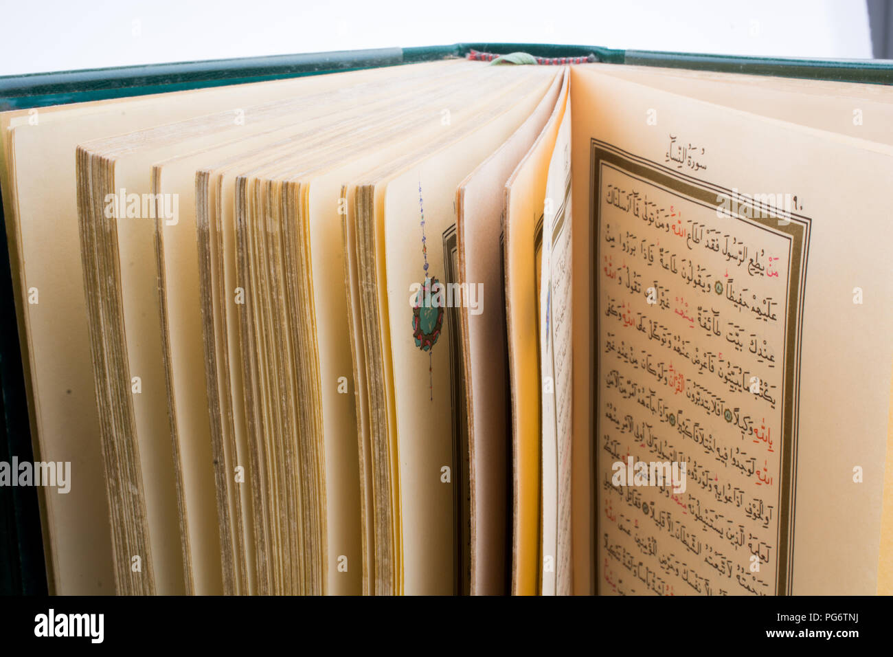 The Holy Quran on a white background Stock Photo - Alamy
