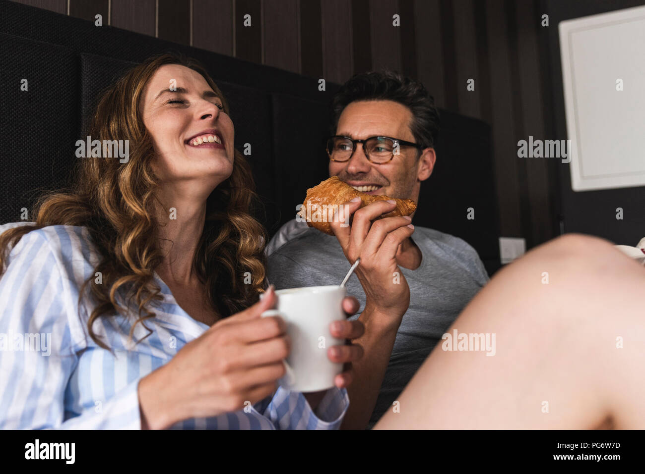 Happy couple having breakfast in bed at home in bedroom Stock Photo - Alamy