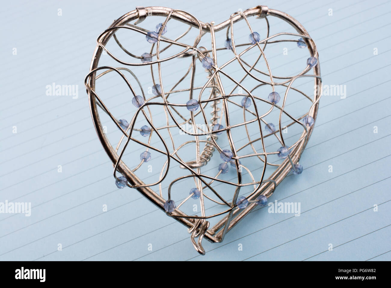 Heart cage on a lined background Stock Photo - Alamy