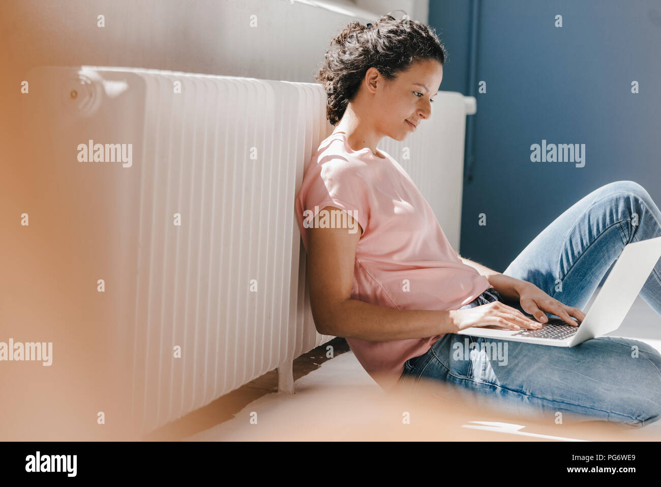 Woman sitting on radiator hi-res stock photography and images - Alamy