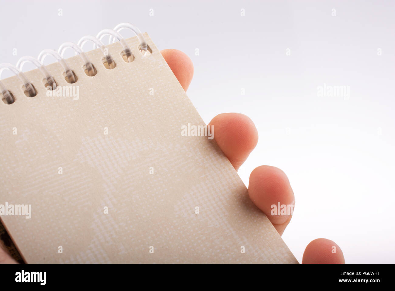 Hand holding Spiral blank notebook on a white background Stock Photo ...