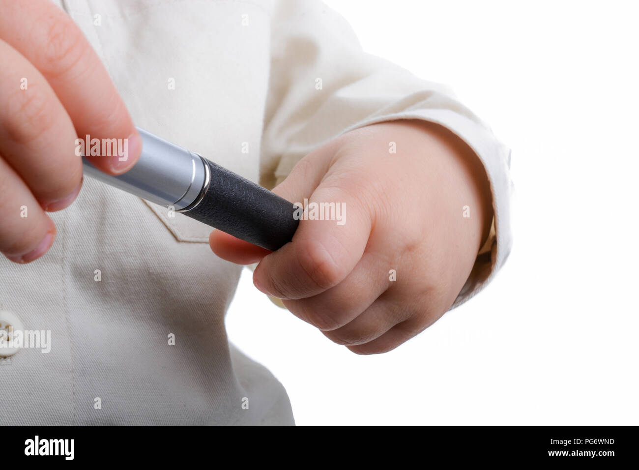 Baby holding a pen in his hand on a white background Stock Photo - Alamy