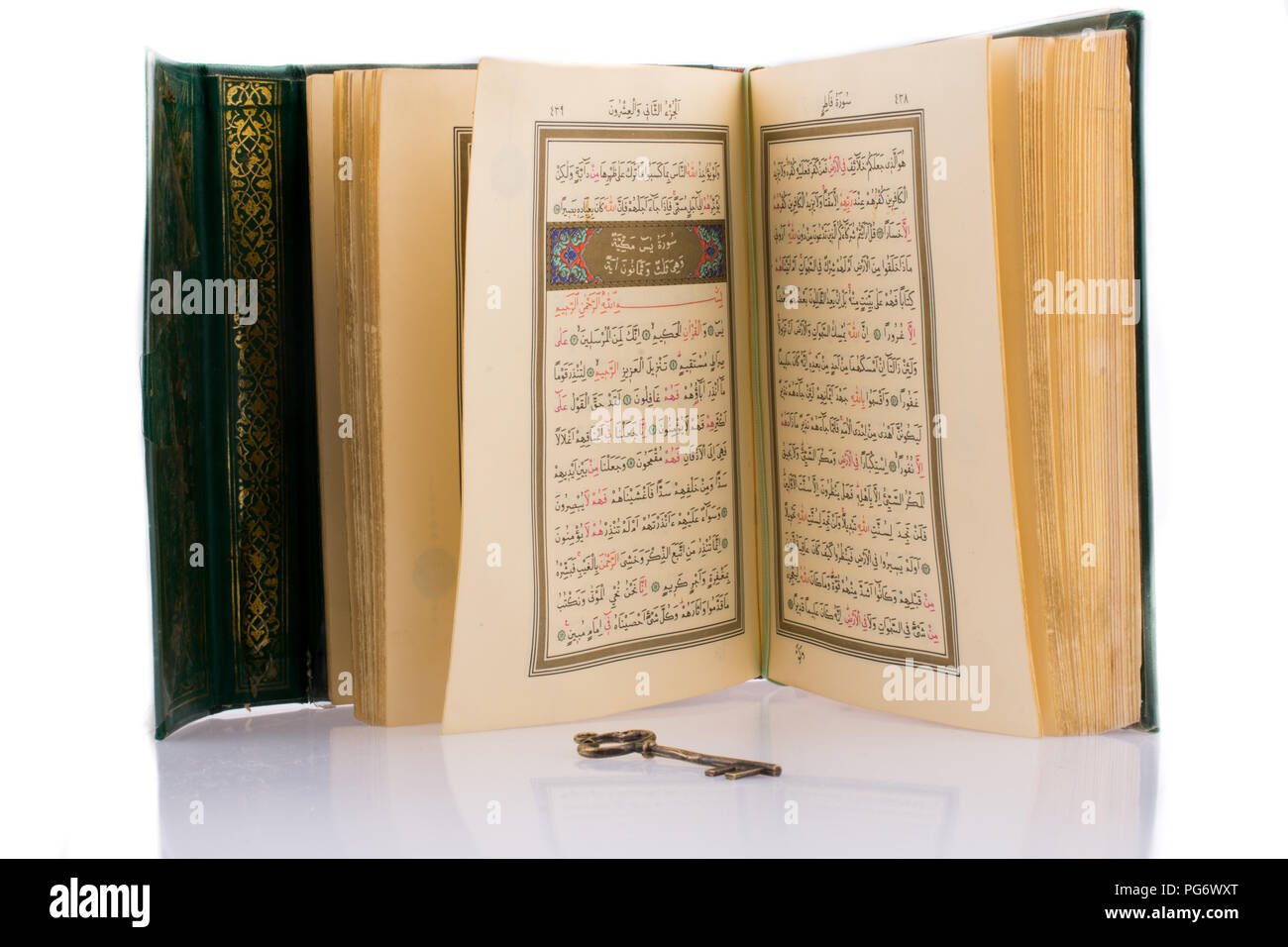 The Holy Quran besides a key on a white background Stock Photo - Alamy