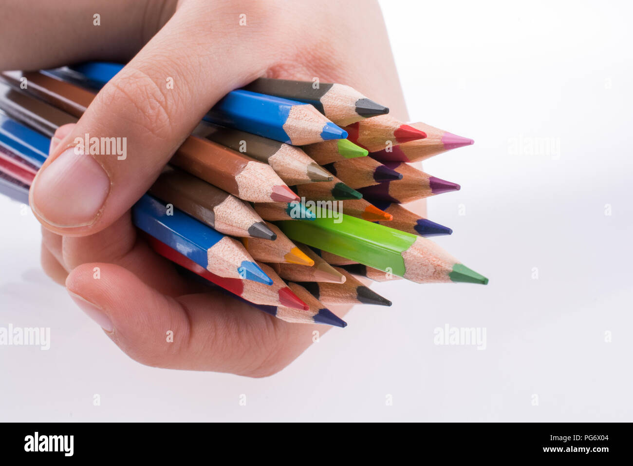 Hand holding color pencils on a white background Stock Photo - Alamy