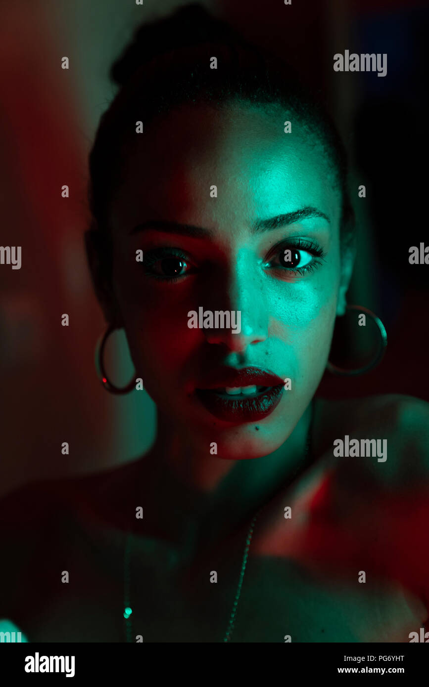 Portrait of beautiful young woman with artificial light Stock Photo - Alamy