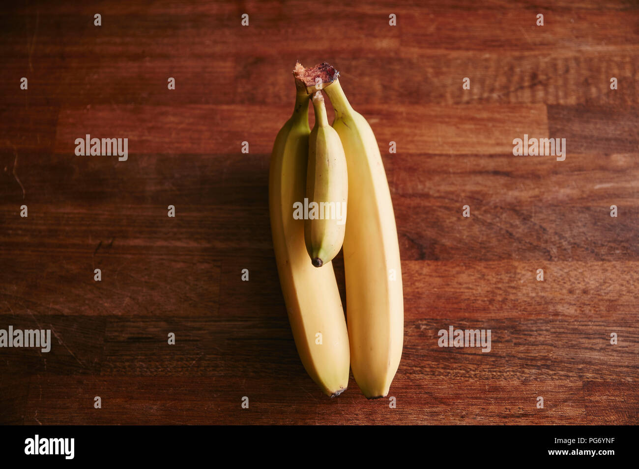 Bunch of two large and one small bananas Stock Photo - Alamy