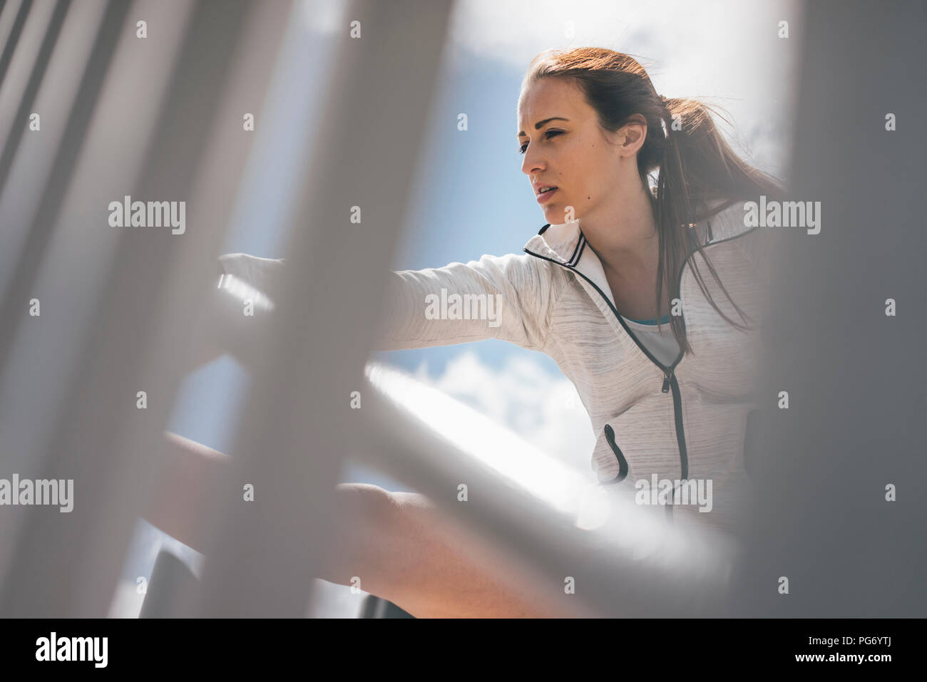 Sportive young woman stretching railing hi-res stock photography and ...