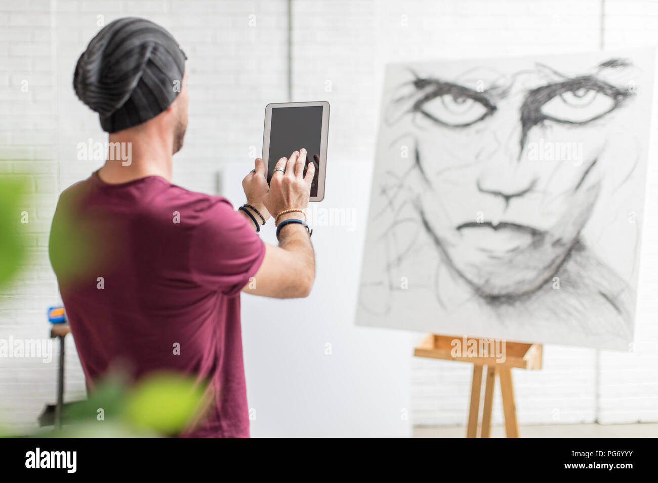 Artist taking photo of his drawing in studio Stock Photo - Alamy
