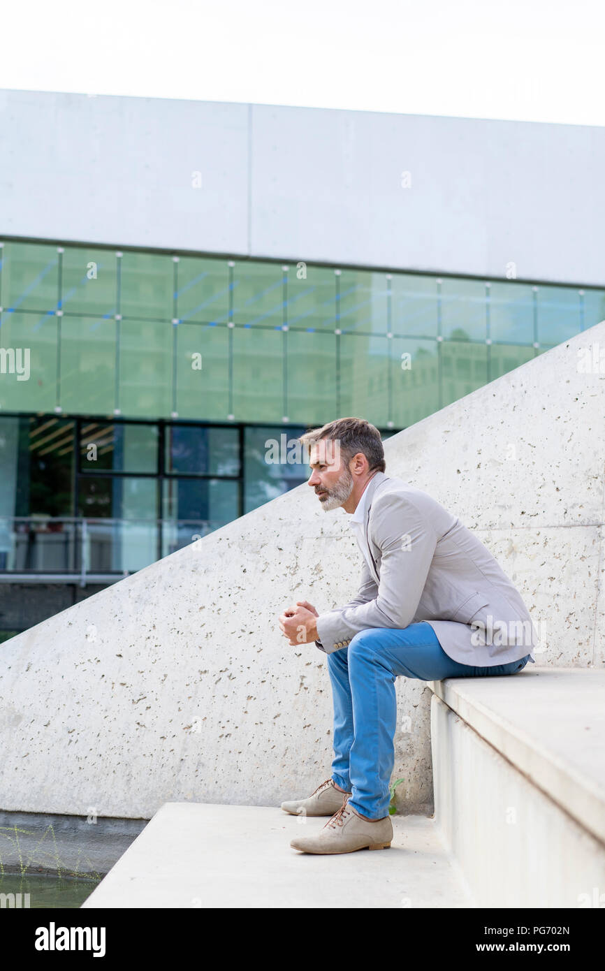 Mature men sitting side side steps hi-res stock photography and images ...