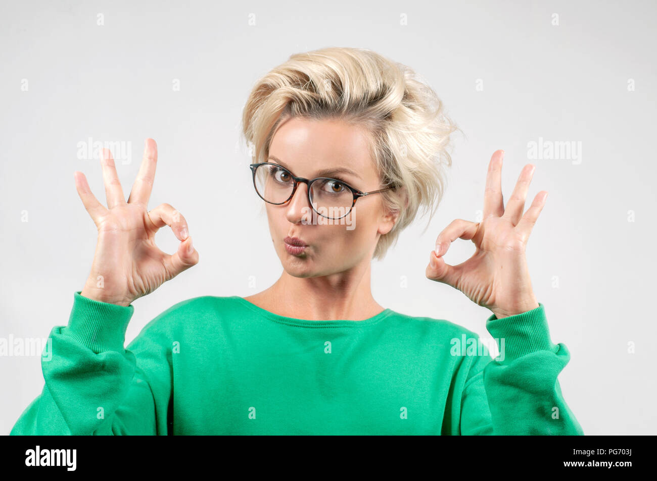 Beautiful young woman is showing ok sign. Positive human emotions Stock ...