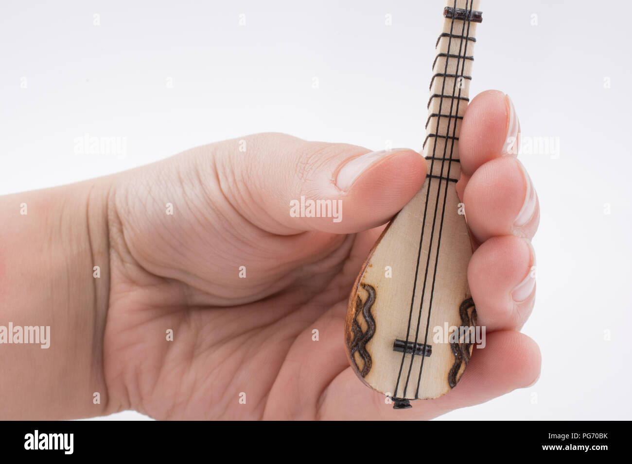Hand holding turkish musical instrument saz on a white background Stock ...