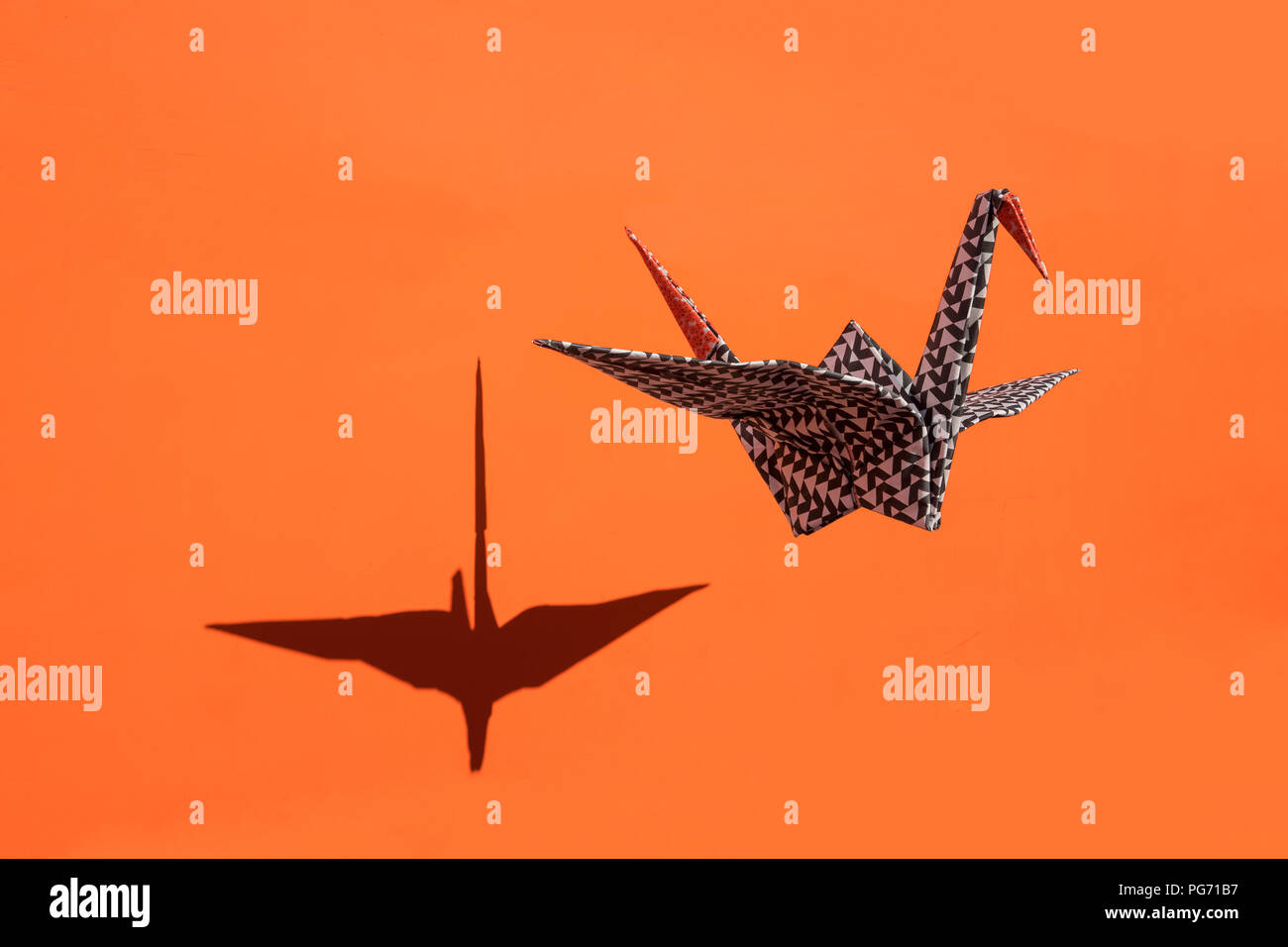 Origami crane, orange background, shadow, copy space Stock Photo - Alamy