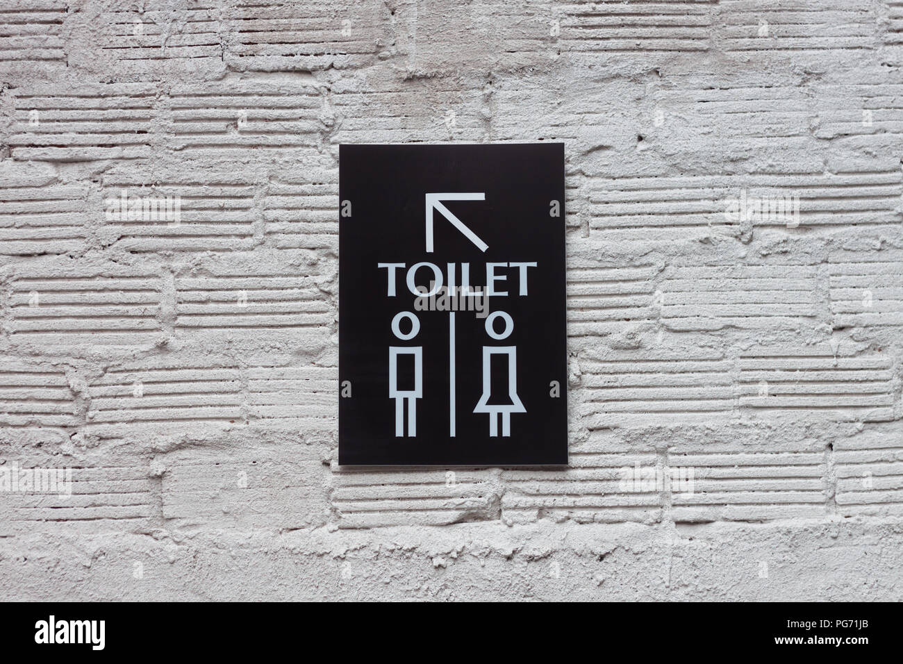 Toilet signs on white wall background, stock photo Stock Photo - Alamy
