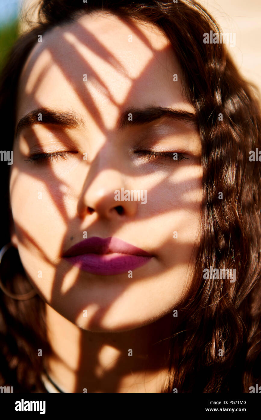 Young woman's face in sunlight Stock Photo - Alamy