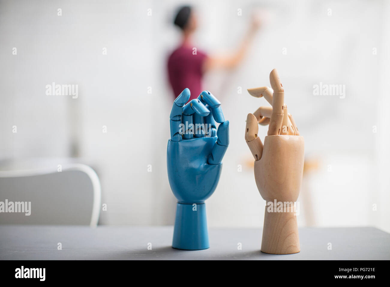 Hand models in studio and artist drawing in background Stock Photo - Alamy