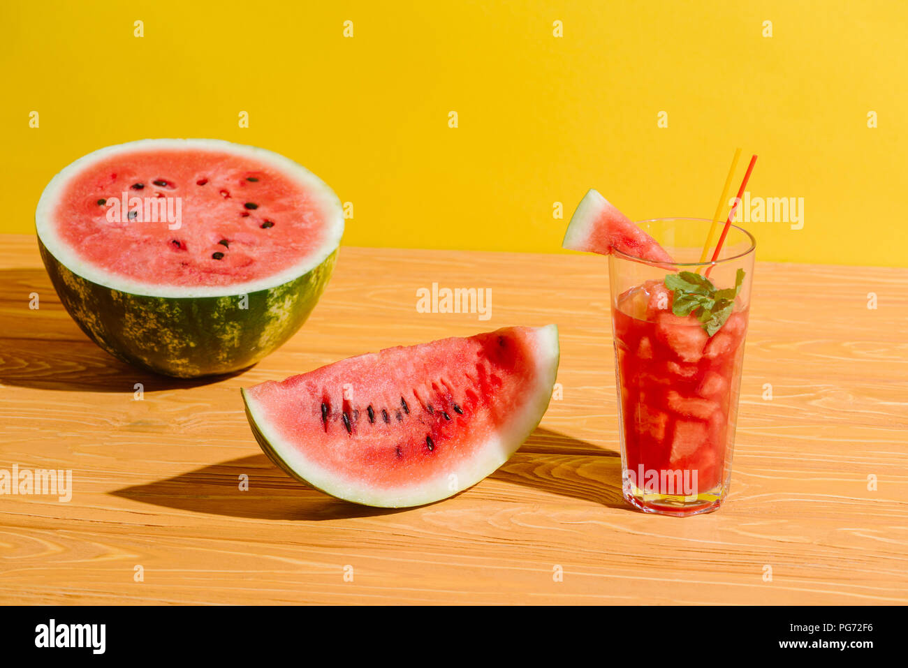 close up view of fresh watermelon and watermelon drink in glass on ...