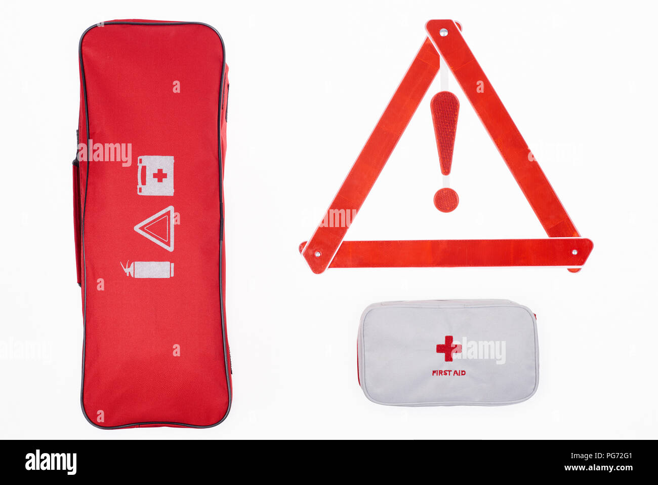 flat lay with automotive handbag, first aid kit and warning triangle ...