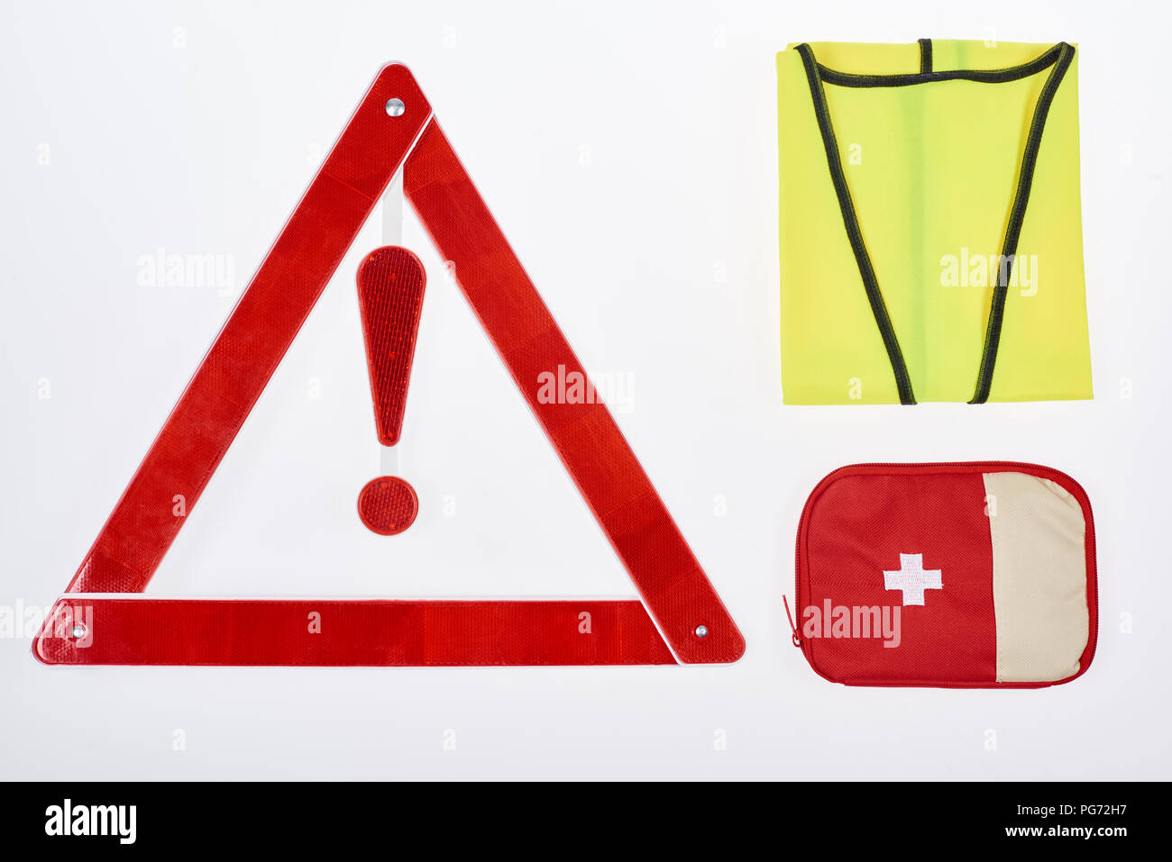 flat lay with warning triangle, first aid kit and reflective vest ...