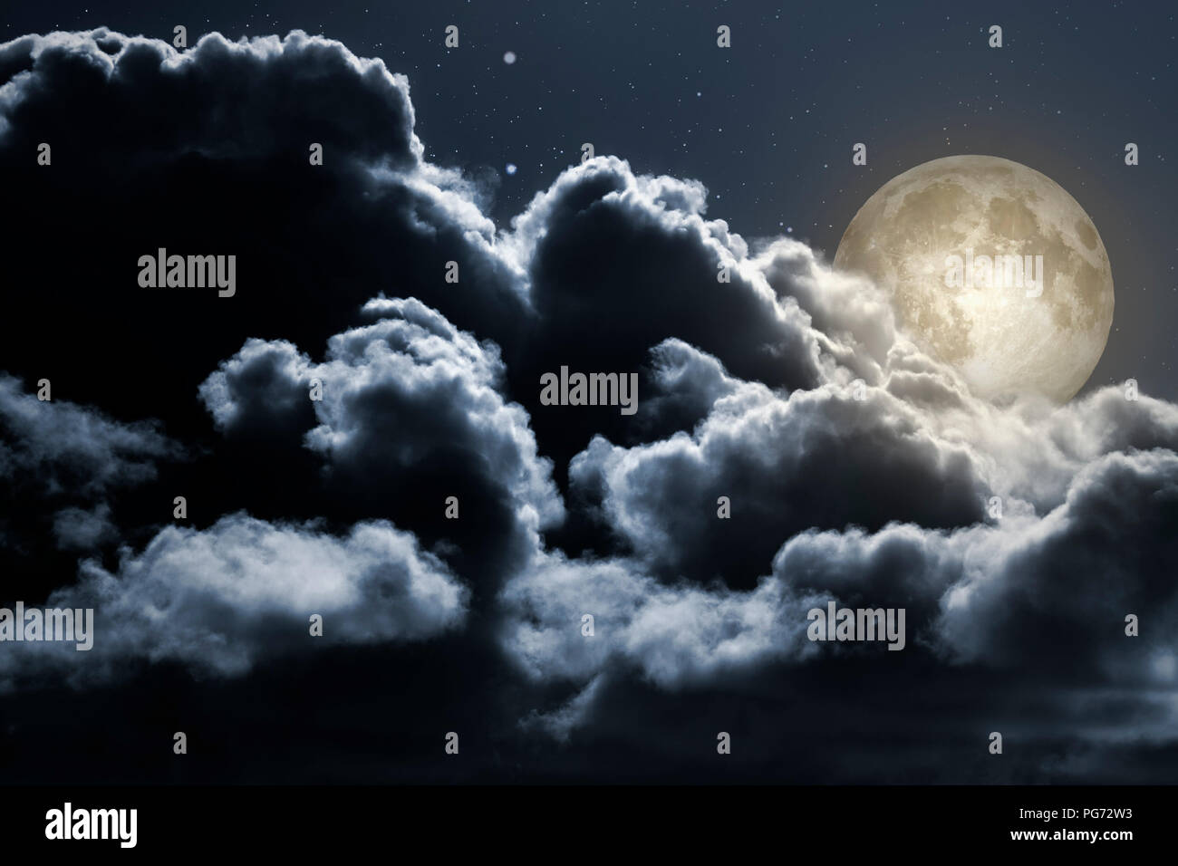 Full moon rises behind strong clouds in a clear night Stock Photo - Alamy