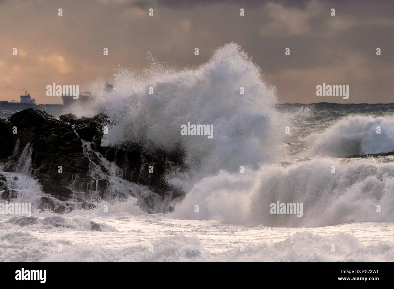 Autumn sea storm at sunset with Atlantic big waves over cliffs from the ...