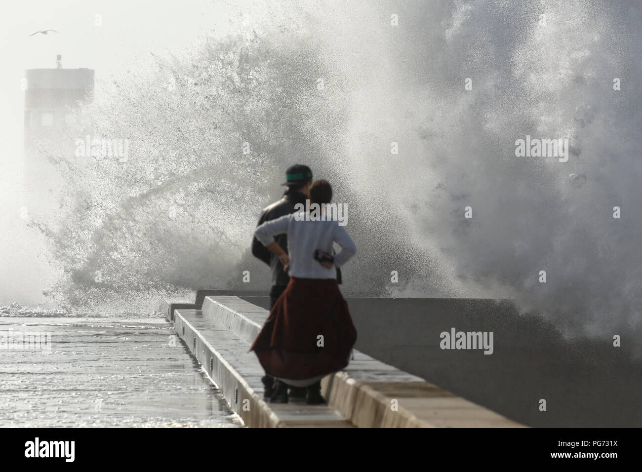 Porto, Portugal - February 2, 2016: People watching violent stormy sea ...