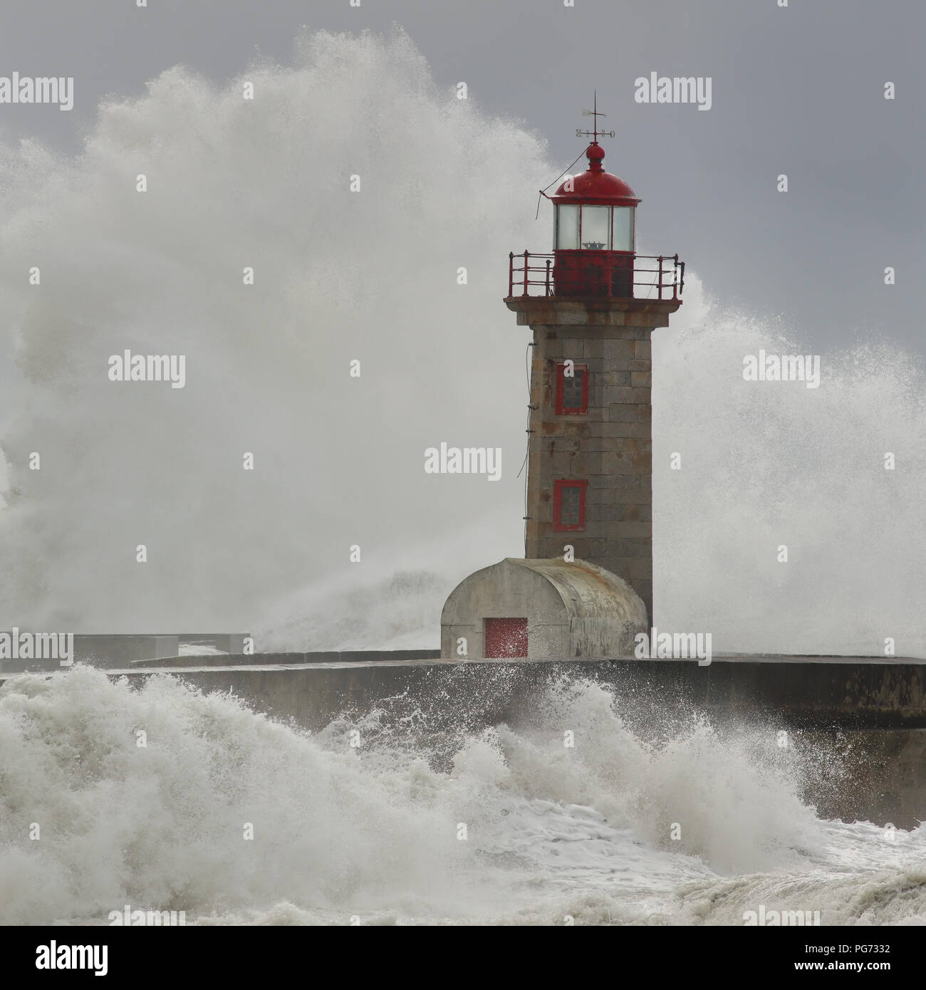 Huge Atlantic waves over Douro river old pier lighthouse in a stormy ...