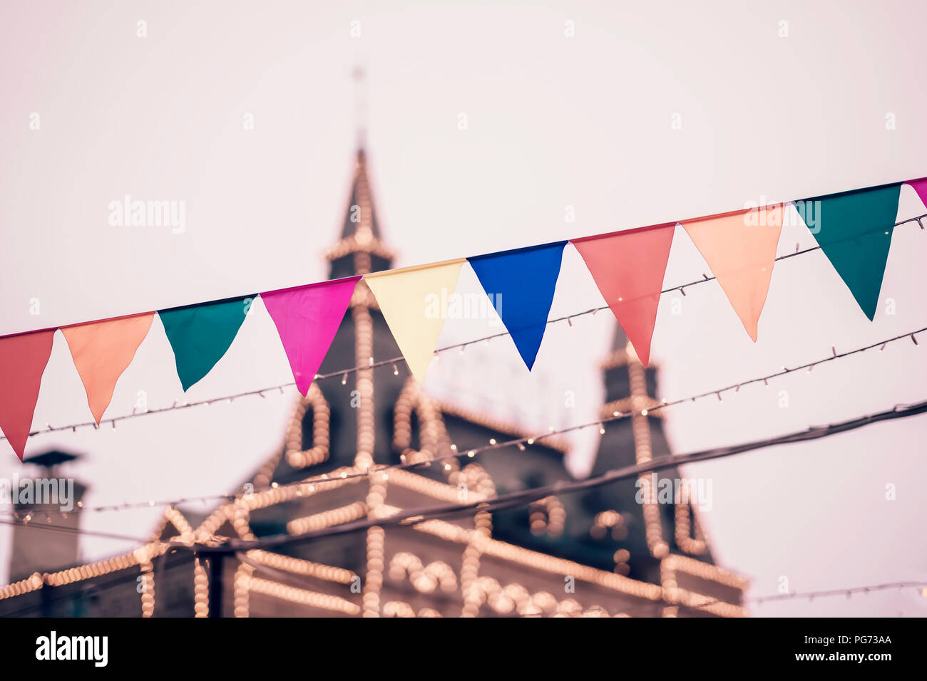 Garland of colorful flags of triangular shape, pennants against palace ...