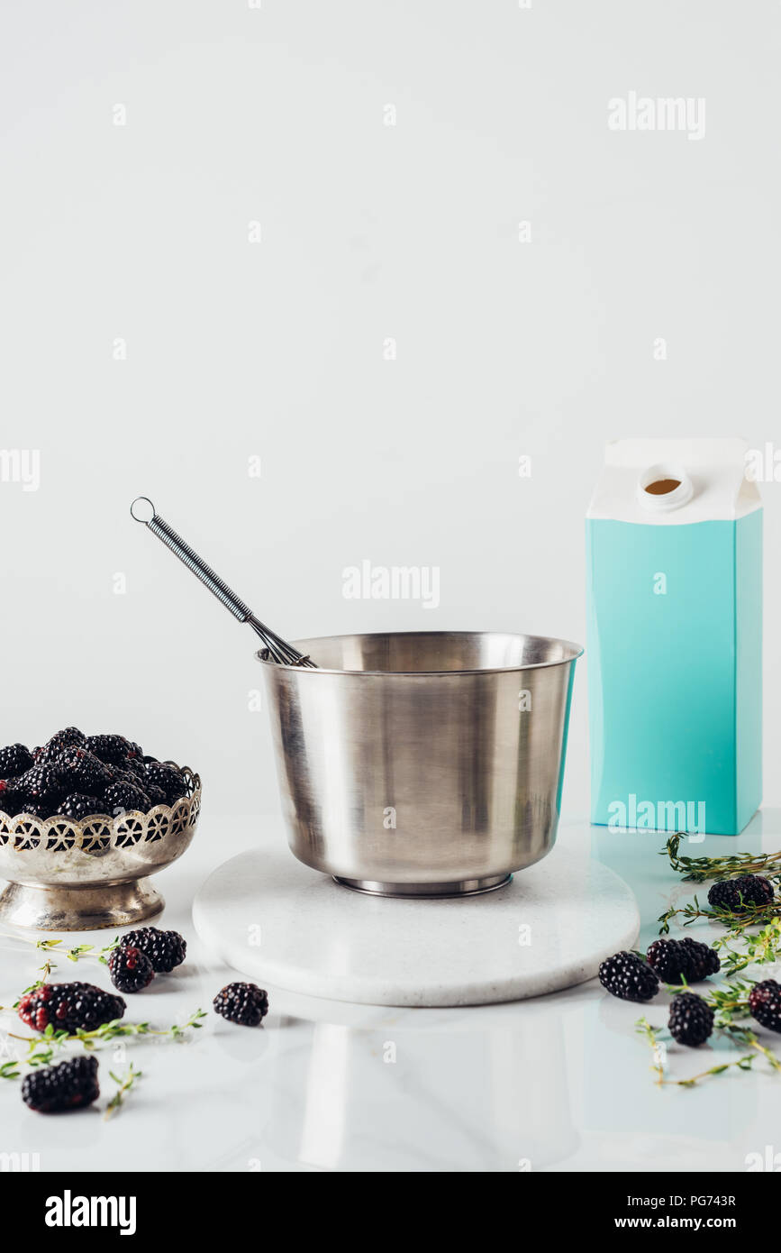 vintage bowl of blackberries with metal bucket and whisk for cooking on ...