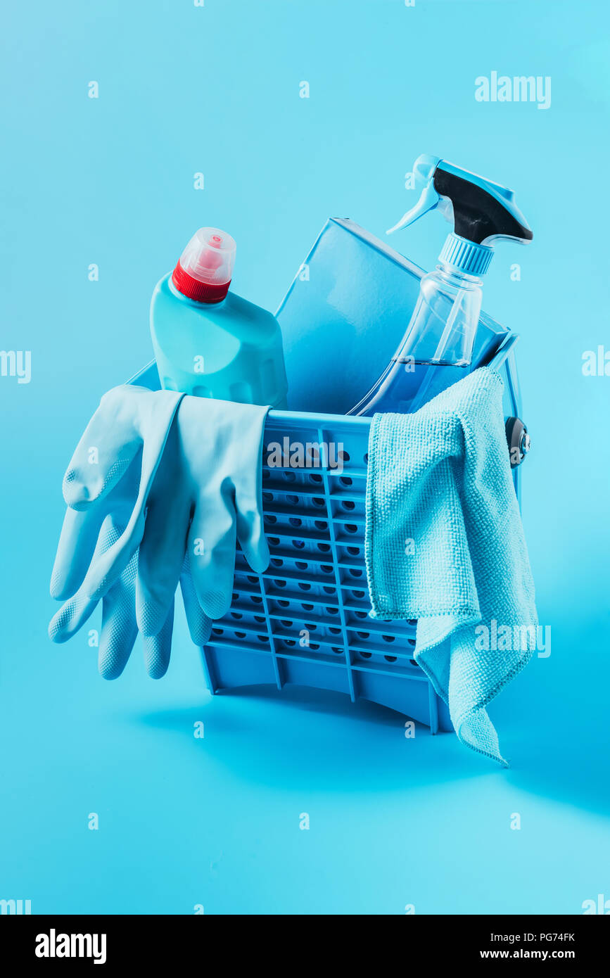 close up view of bucket with washing powder, cleaning fluids, rubber ...