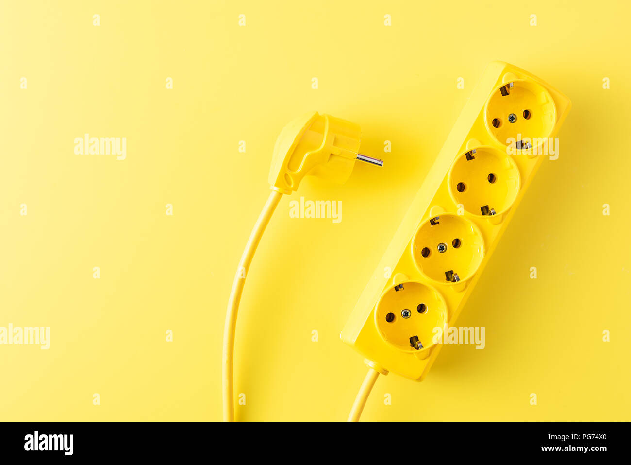 top view of yellow socket outlet and plug on yellow background Stock ...
