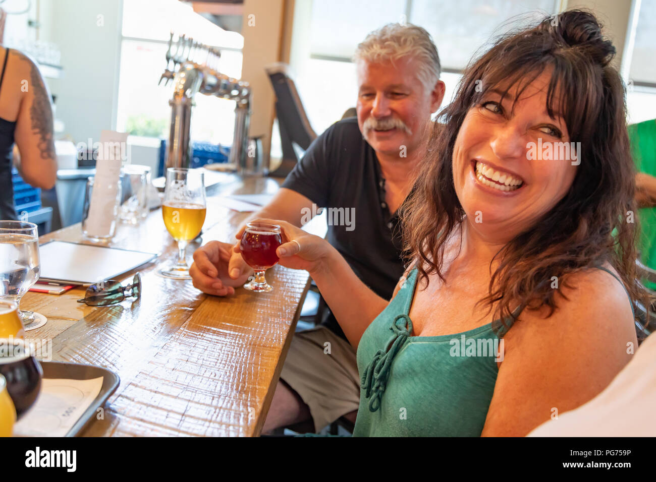 Group of Friends Enjoying Glasses of Micro Brew Beer At Bar Stock Photo ...