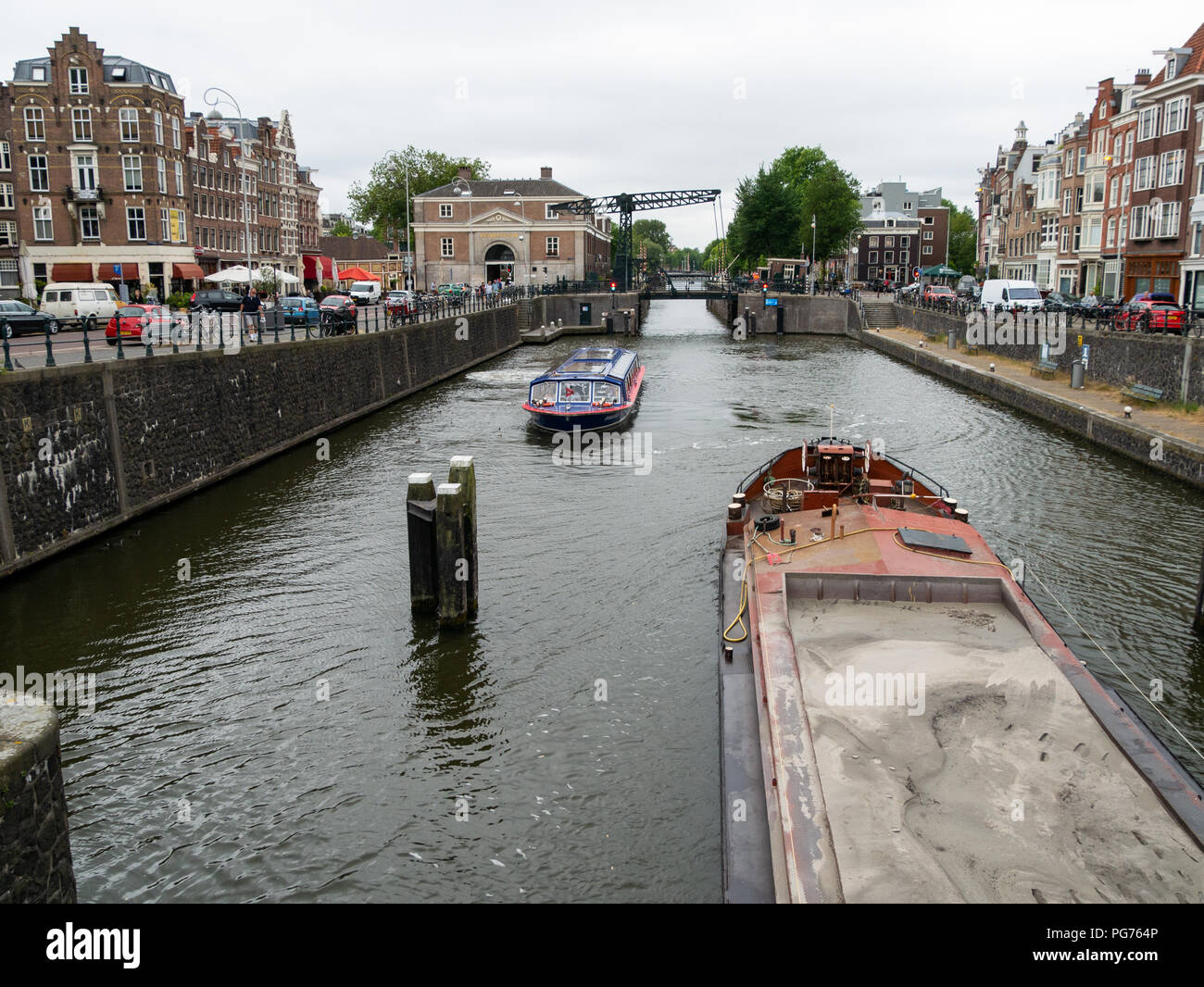 Cargo barge and passenger barge, Canal, Amsterdam, Netherlands Stock ...