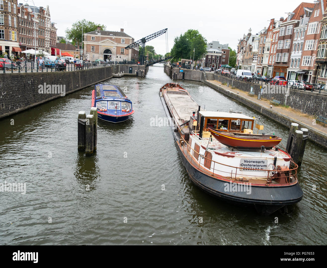 Cargo barge and passenger barge, Canal, Amsterdam, Netherlands Stock ...