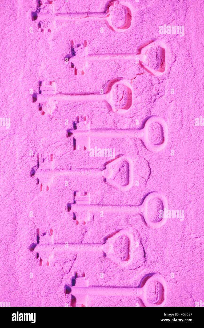 shapes of keys on pink colored powder texture Stock Photo - Alamy