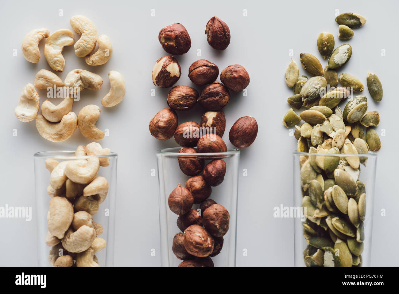 variety of nuts in glass cups isolated on white background Stock Photo ...