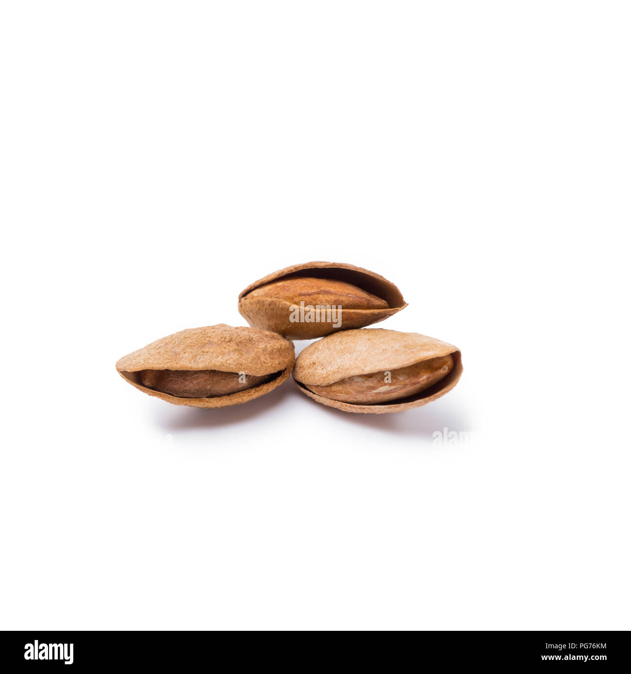 handful of almonds in nutshells isolated on white background Stock ...